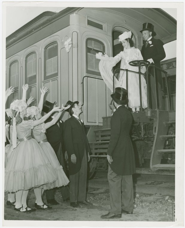 Railroads on Parade - Man and woman in costume standing on train with ...
