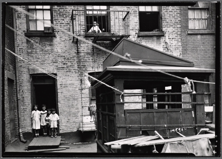 Children posed in rear tenement courtyard - NYPL Digital Collections