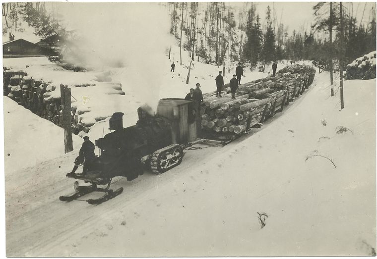 Steam driven tractor sled carrying logs. - NYPL Digital Collections