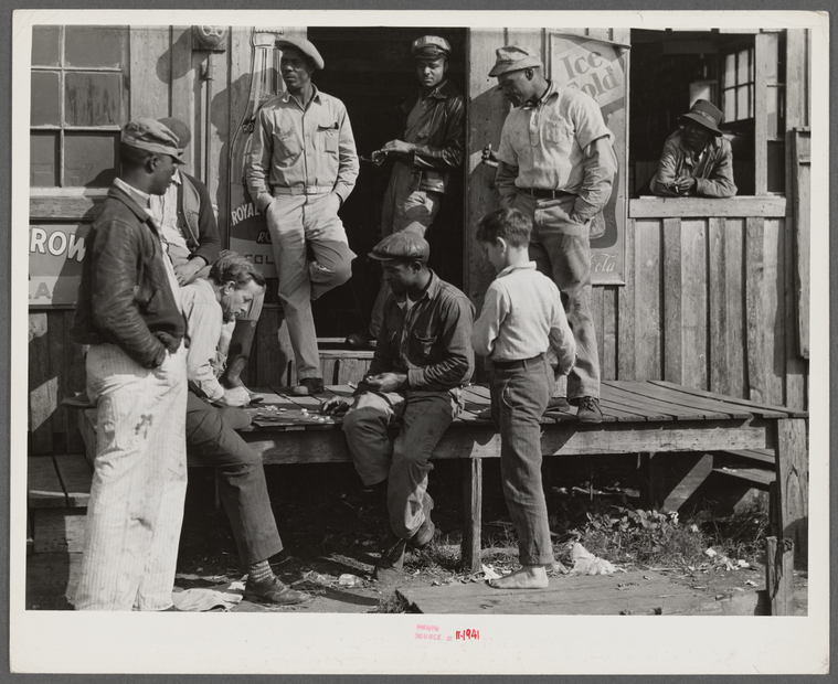 Migratory laborers playing checkers in front of juke joint during slack ...